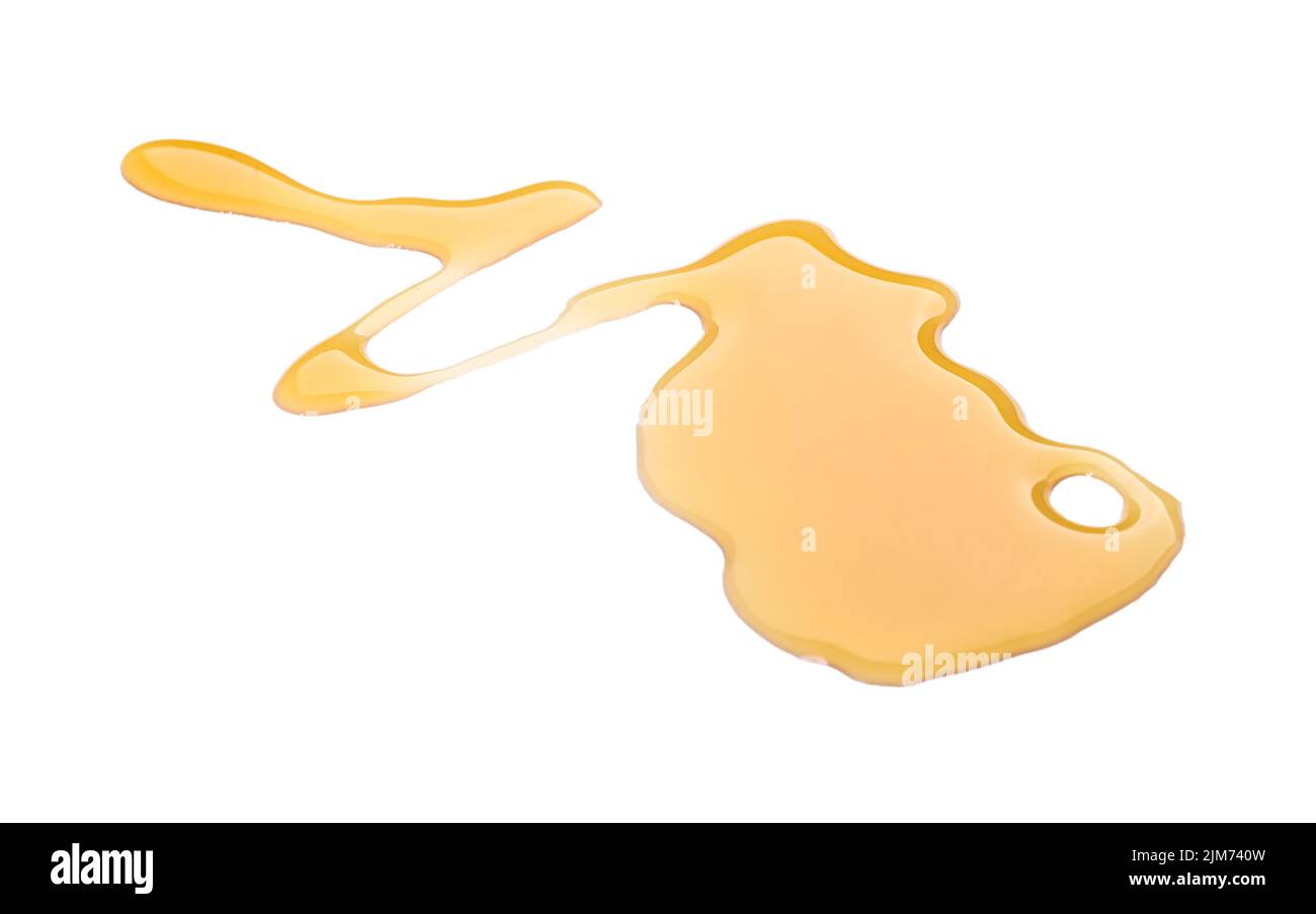 Spilled maple syrup isolated on white background Stock Photo - Alamy
