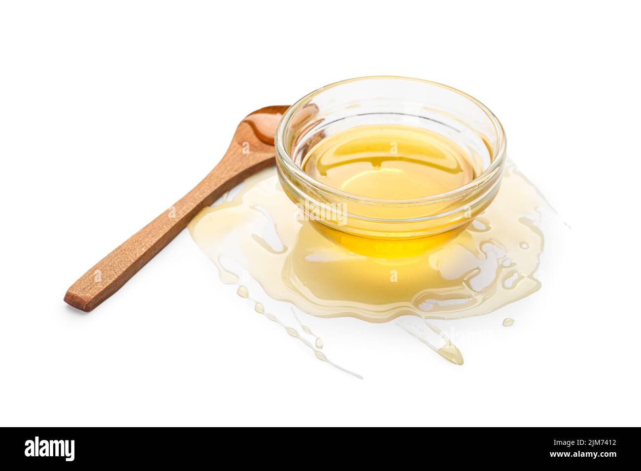 Bowl and wooden spoon of tasty maple syrup on white background Stock ...