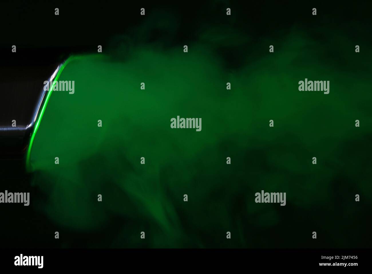 A green neon powder isolated on a black background Stock Photo - Alamy