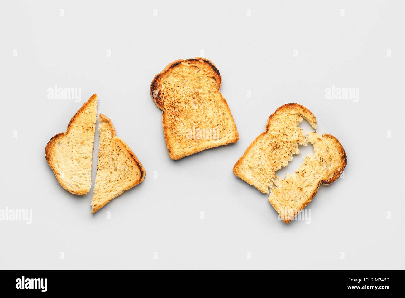 Crispy toasts on light background Stock Photo - Alamy