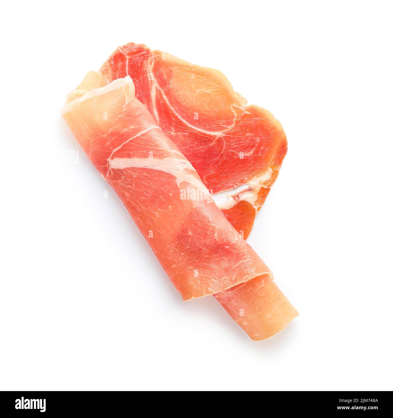 Rolled slice of jamon on white background Stock Photo - Alamy