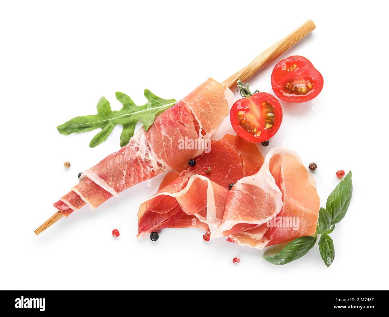 Composition with delicious jamon on white background Stock Photo - Alamy