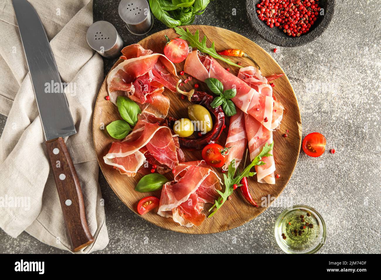 Wooden plate with delicious jamon on grunge background Stock Photo - Alamy