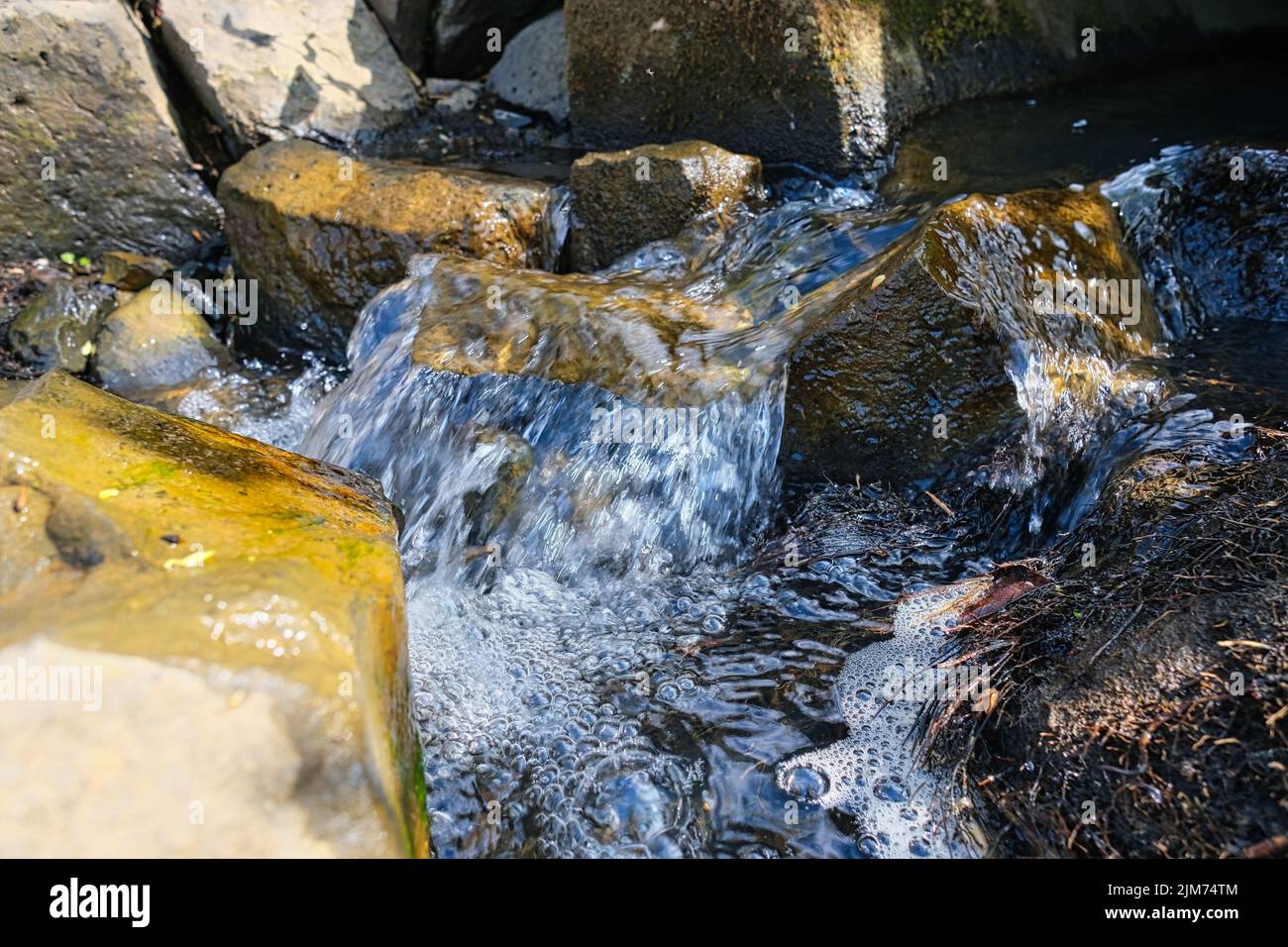 small stream falling on stones,natural water source Stock Photo - Alamy