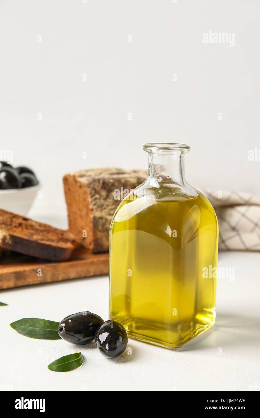 Bottle of fresh olive oil on light background Stock Photo - Alamy