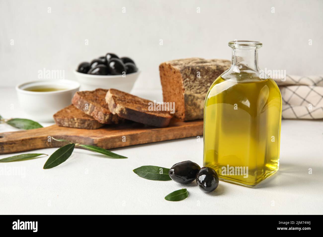 Bottle of fresh olive oil on light background Stock Photo - Alamy