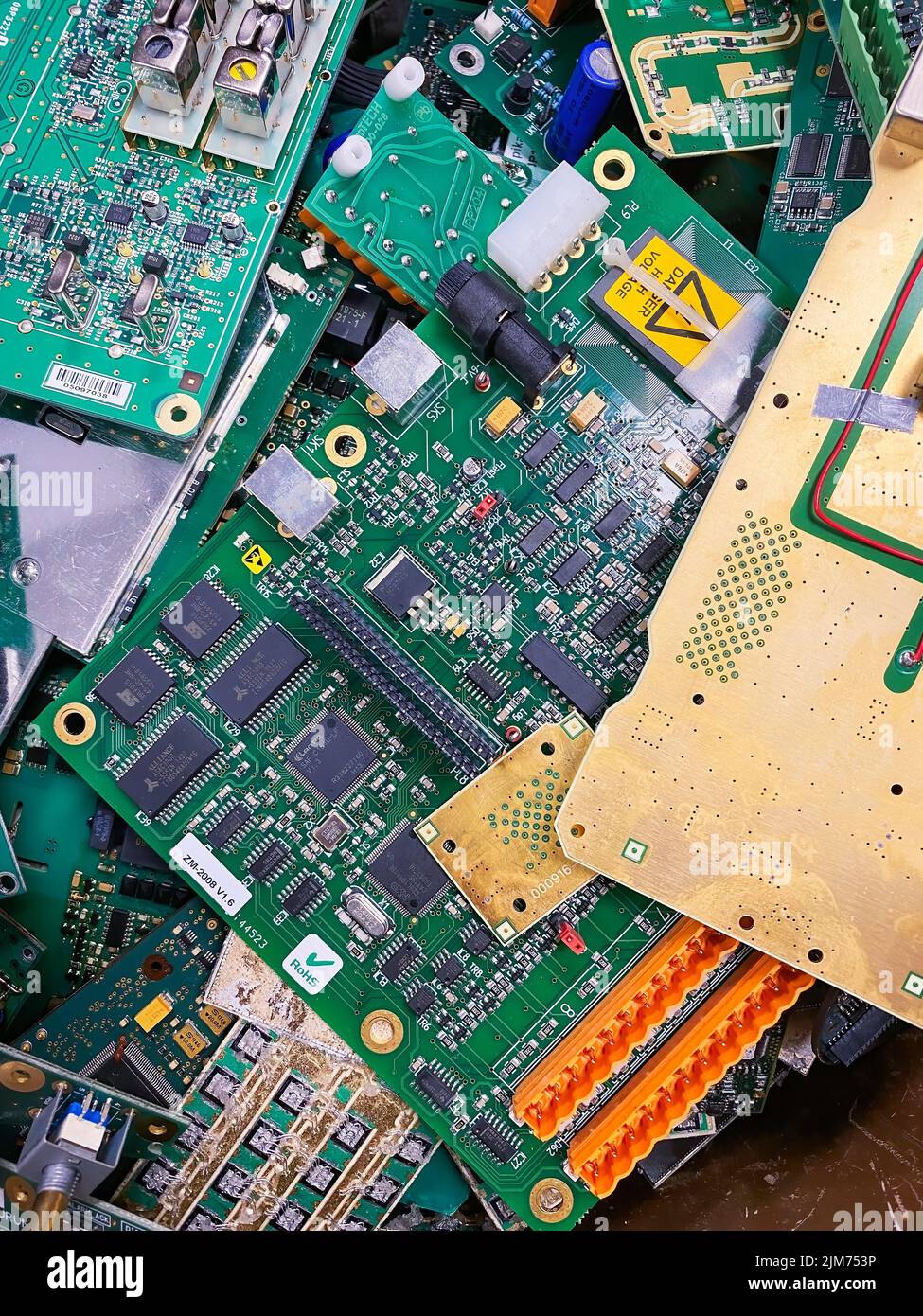 Computer printed circuit boards in a heap, showing gold plating. High ...