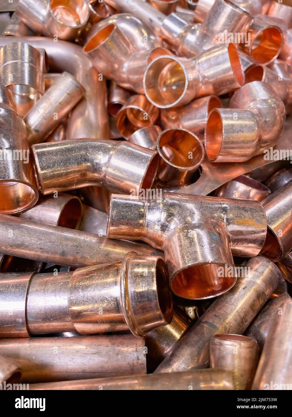 Copper tubes and elbows used by plumbers for water and gas installation ...
