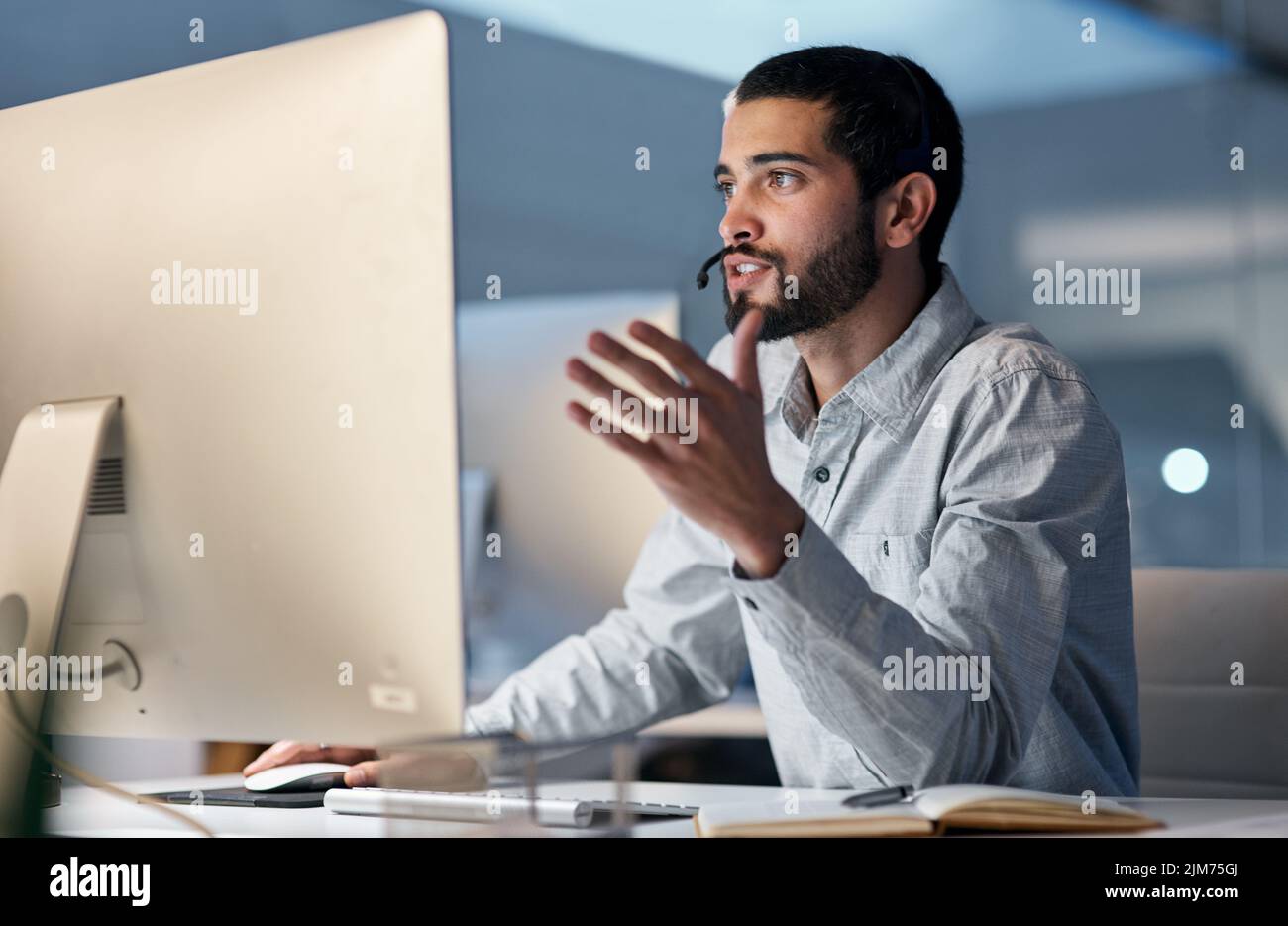 Every client deserves to be heard. a young man using a headset and ...