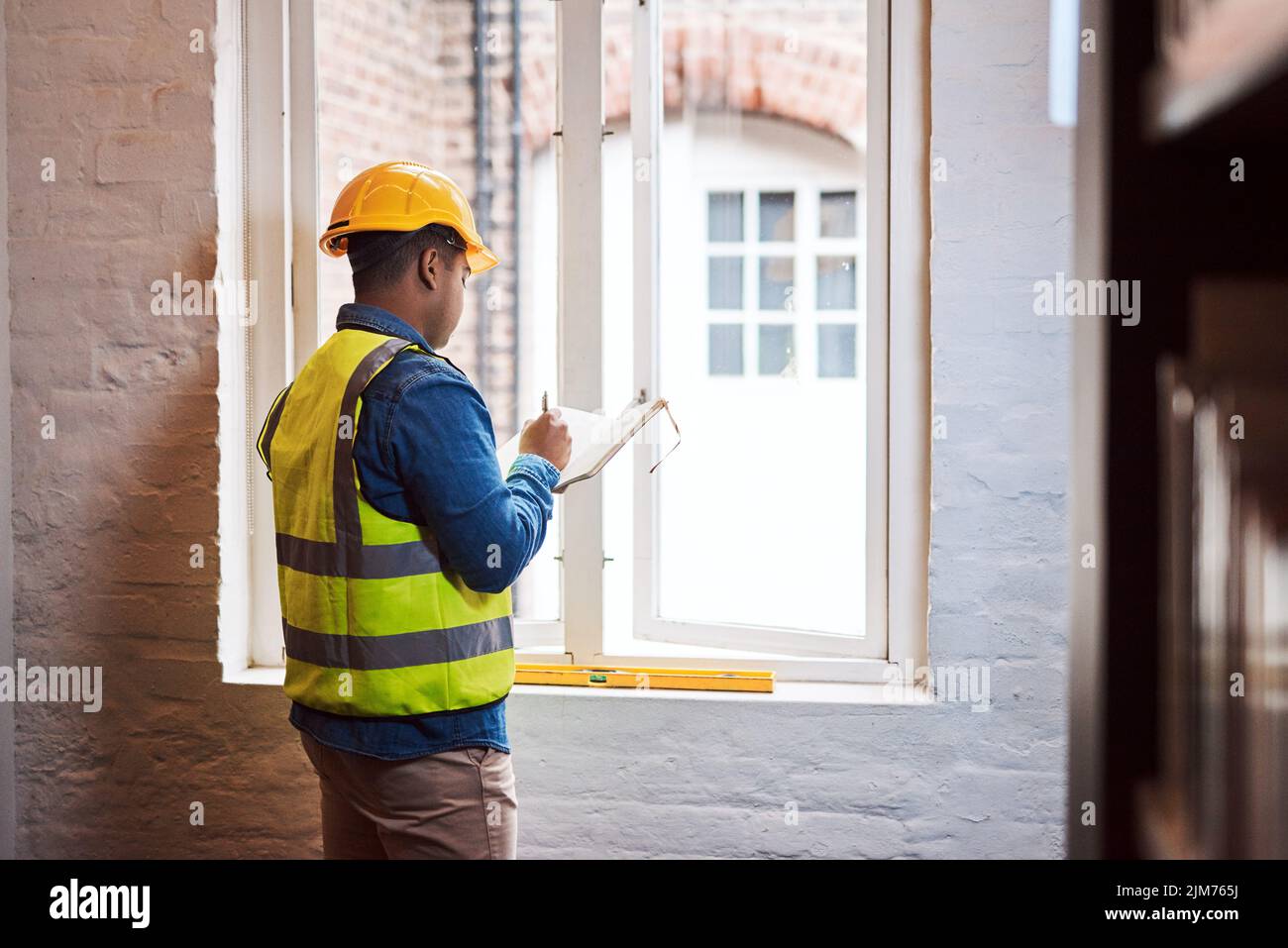 Doing it right costs less than doing it over. a engineer making notes ...