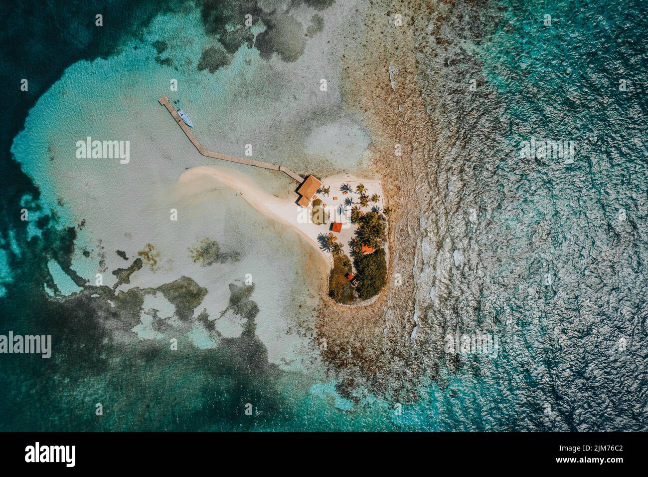 An aerial top view of the Goff's Caye island in the Caribbean Sea ...