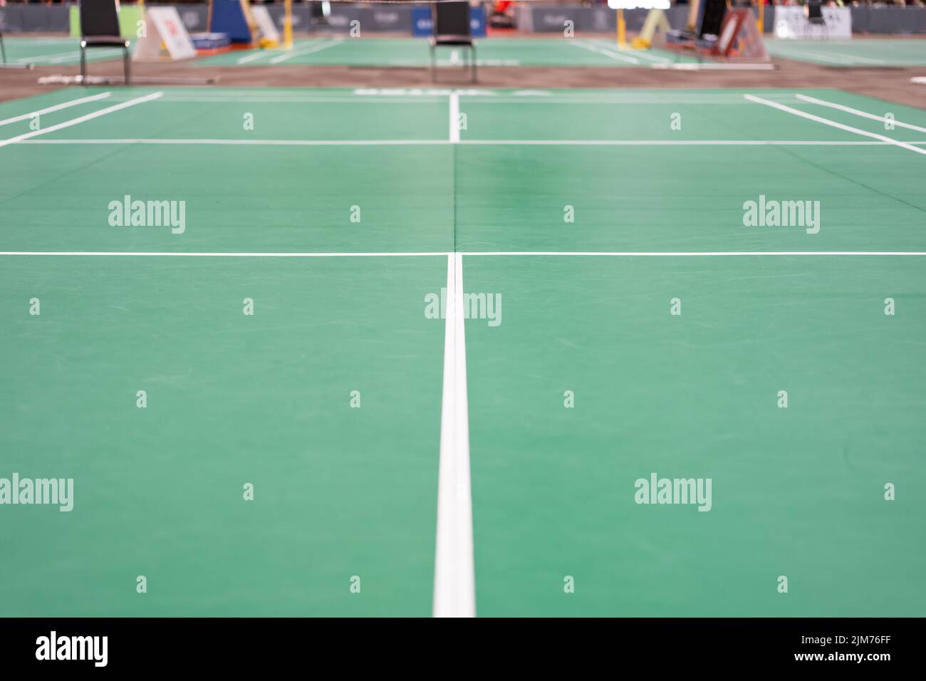 empty green used badminton court background is ready for playing ...