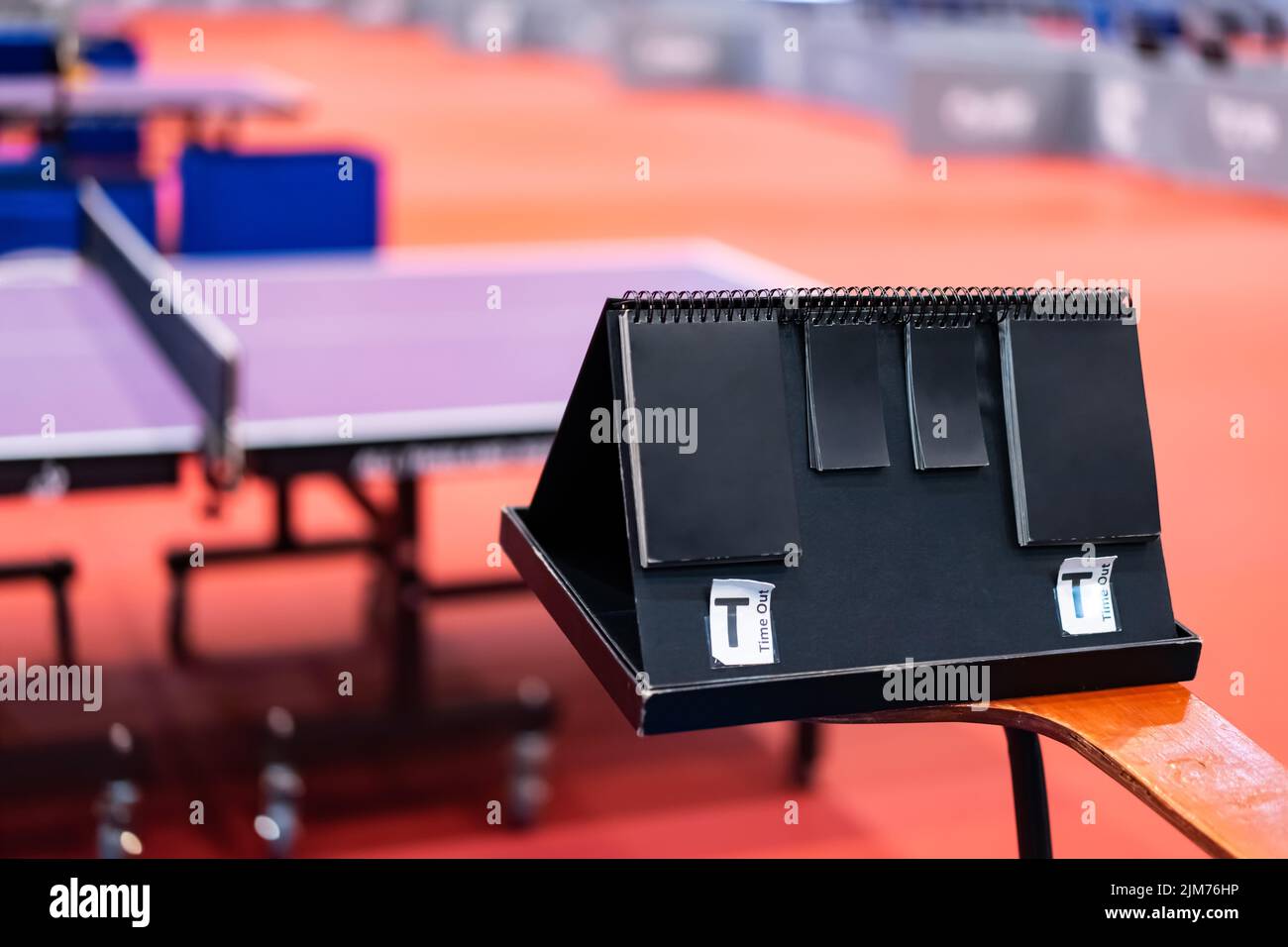 A tennis table black scoreboard is placed next to the table tennis ...