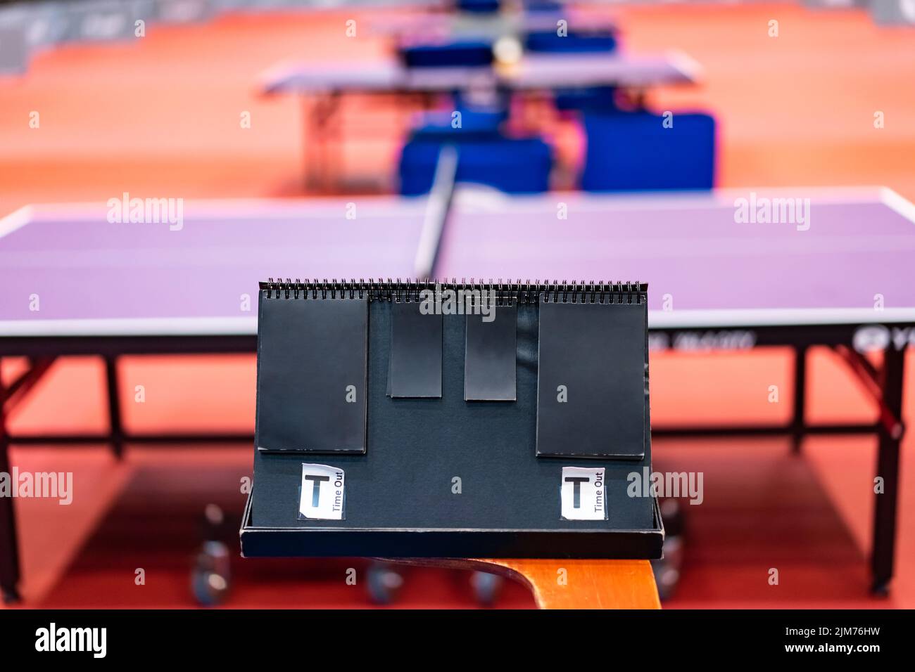 A tennis table black scoreboard is placed next to the table tennis ...