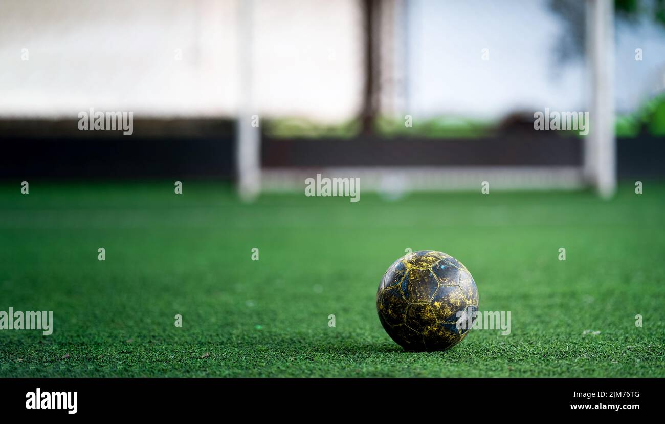 Experienced soccer ball is placed on a grass field. We can only imagine ...