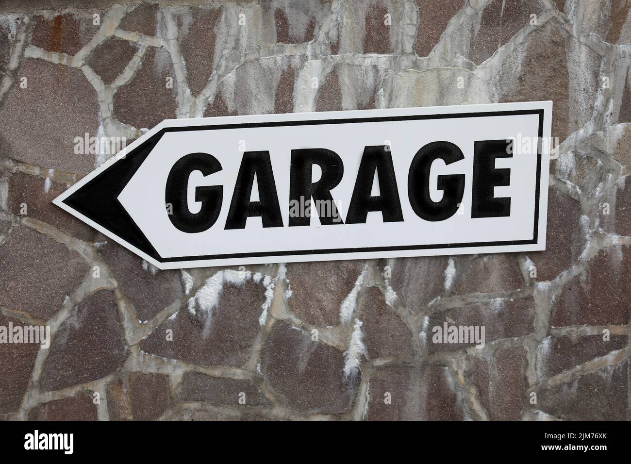 arrow with big garage word indicating the direction for parking cars ...