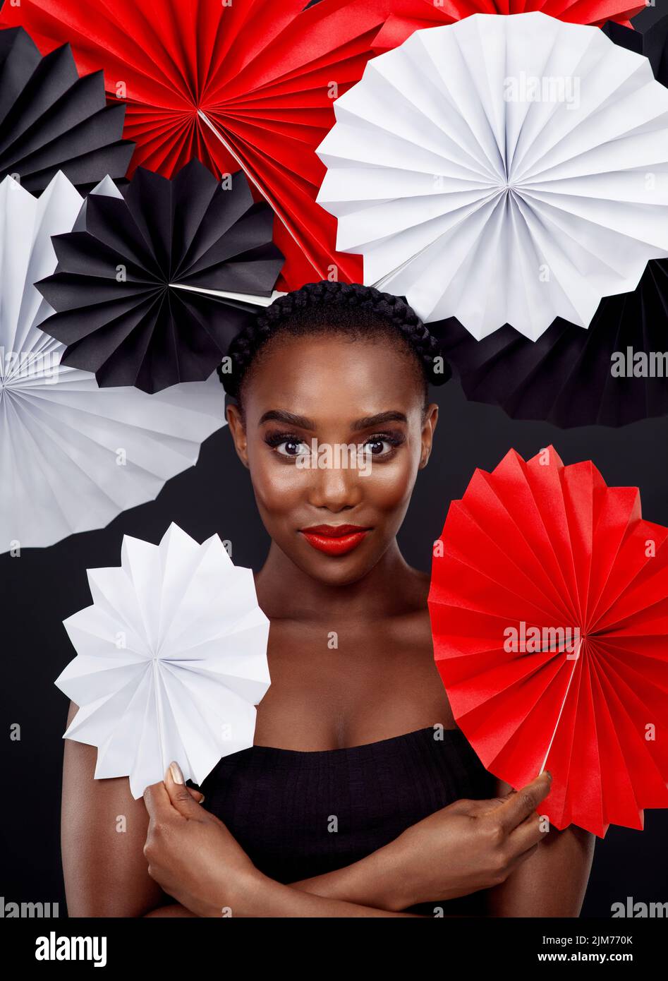 Its a frenzy of fans. Studio shot of a beautiful young woman posing ...