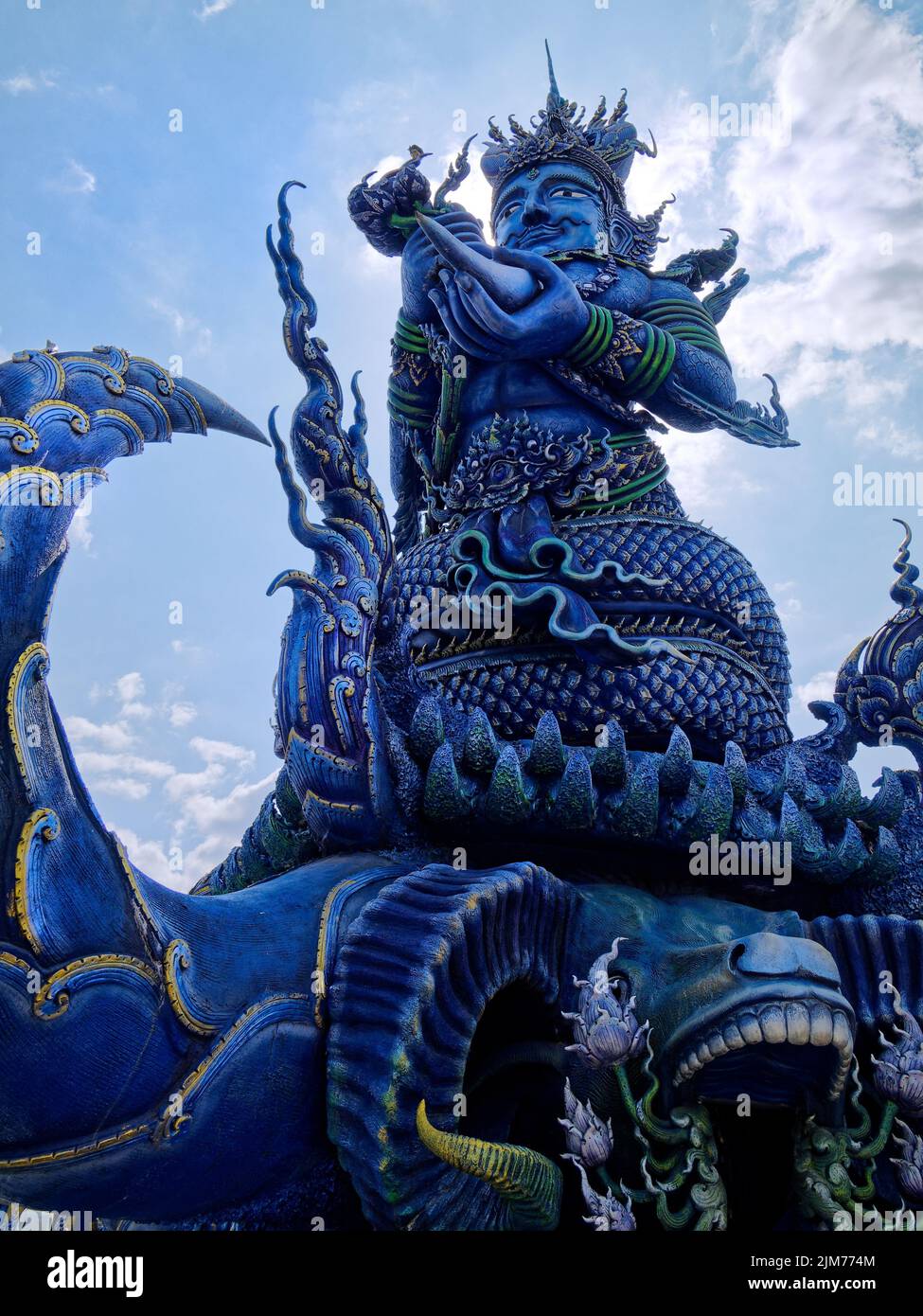 A beautiful shot of a big blue Buda statue in Wat Rong Suea Ten (Blue ...