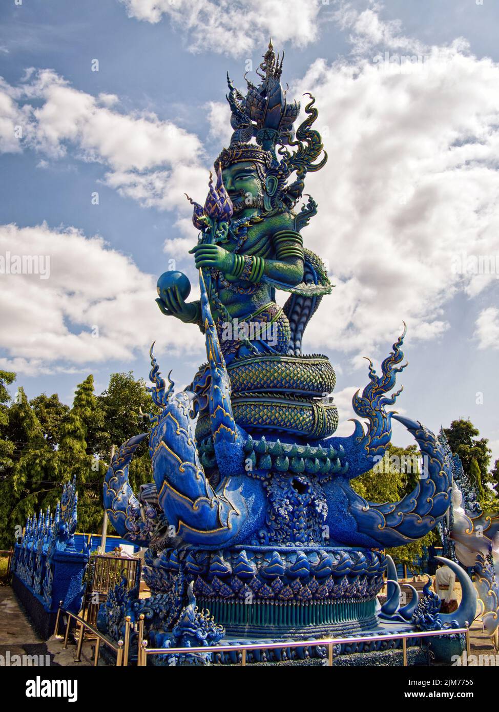 A beautiful shot of a big blue Buda statue in Wat Rong Suea Ten (Blue ...