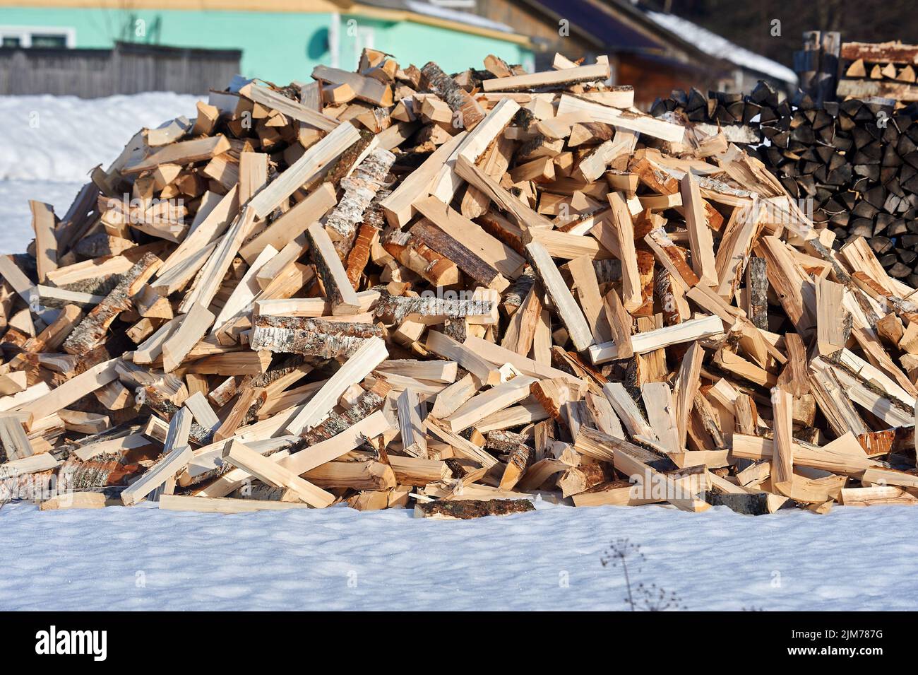 A pile of split firewood lies on the snow in winter Stock Photo - Alamy