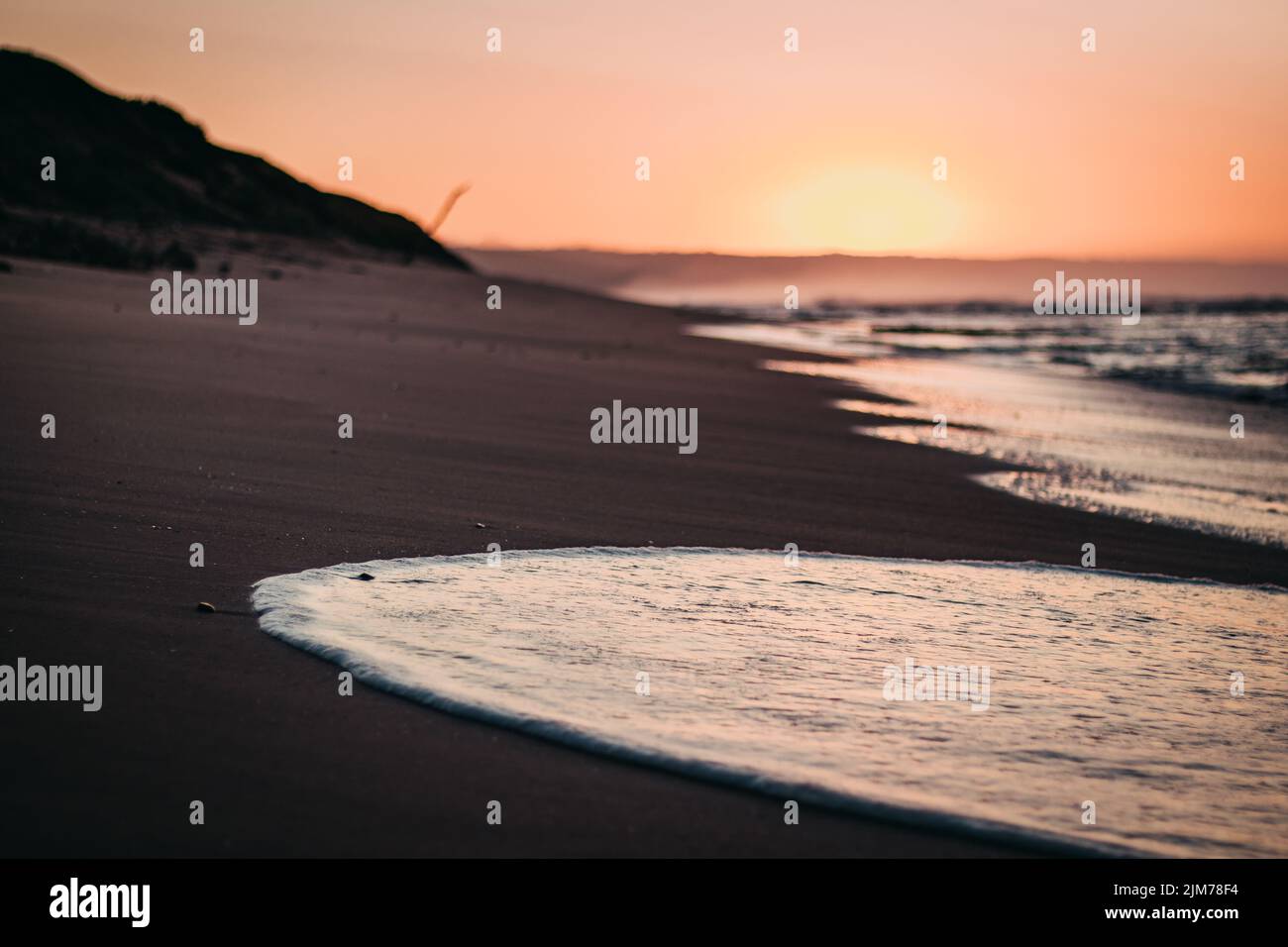 The sunrise on a beach in Mossel Bay located on the east coast of South ...