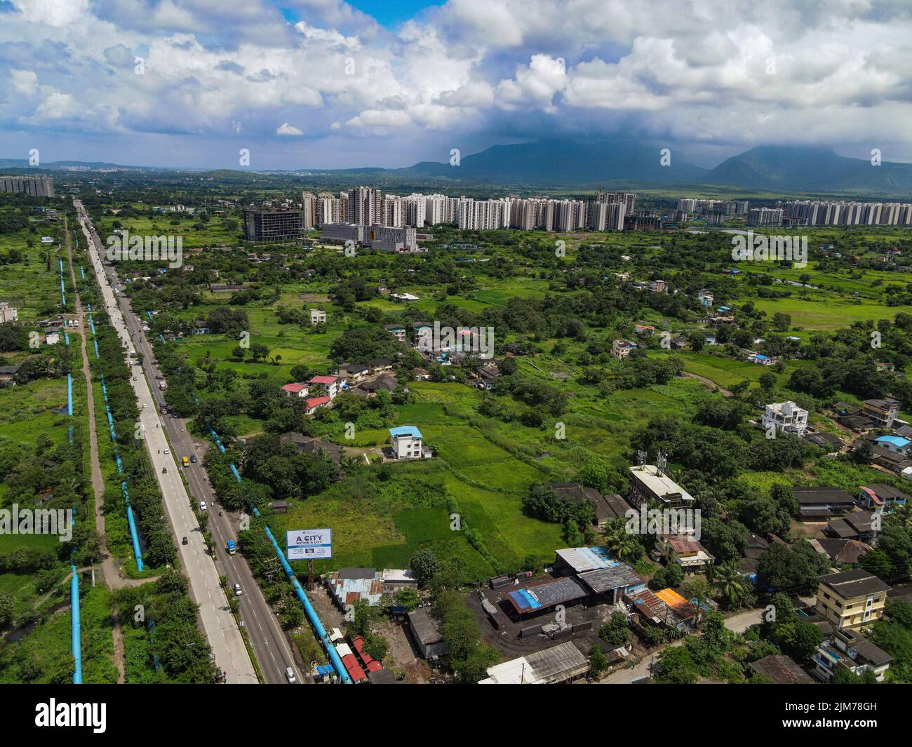 An aerial view of rural community with tall city buildings in the ...