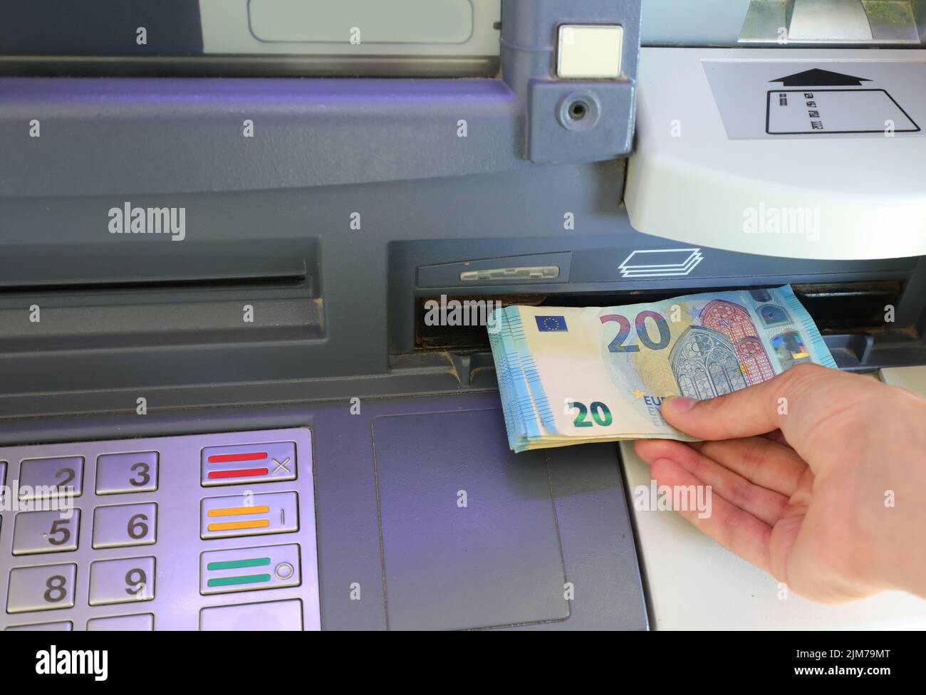 hand while withdrawing money European banknotes from an ATM cash ...