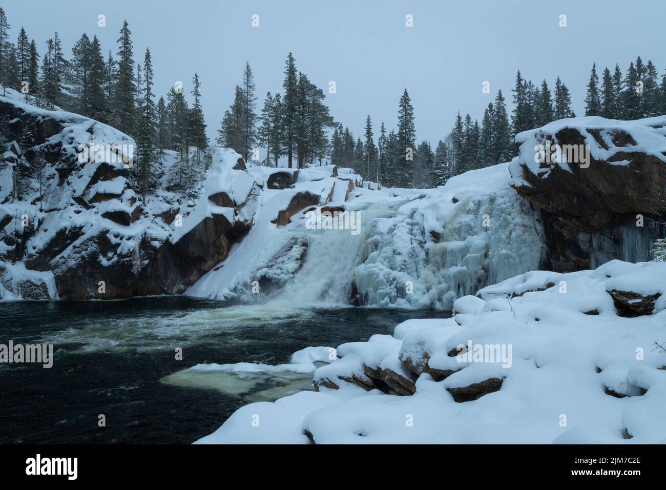 Hyttfossen waterfall on Gaula river in winter look. Snowy landscape of ...