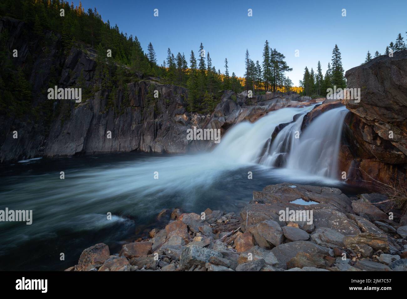 Hyttfossen waterfall during sunset time. Long exposure time on flowing ...