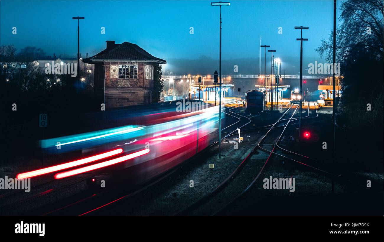 An aerial view of a long exposure train driving through train station ...