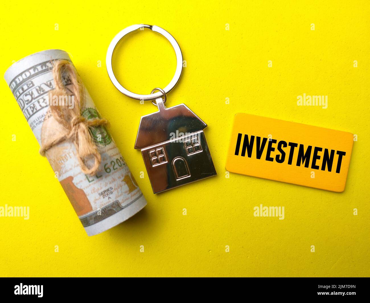 A top view of banknote,house keychain and wooden board with word ...