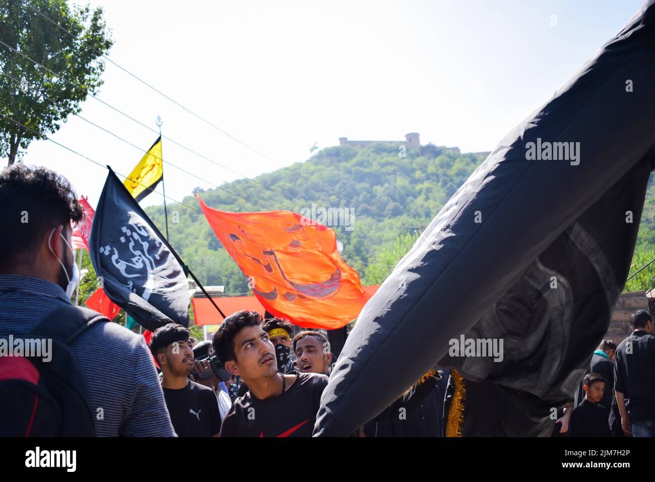 Shia muslims unfurling flags during muharram Procession Shia muslims unfurling flags during ...