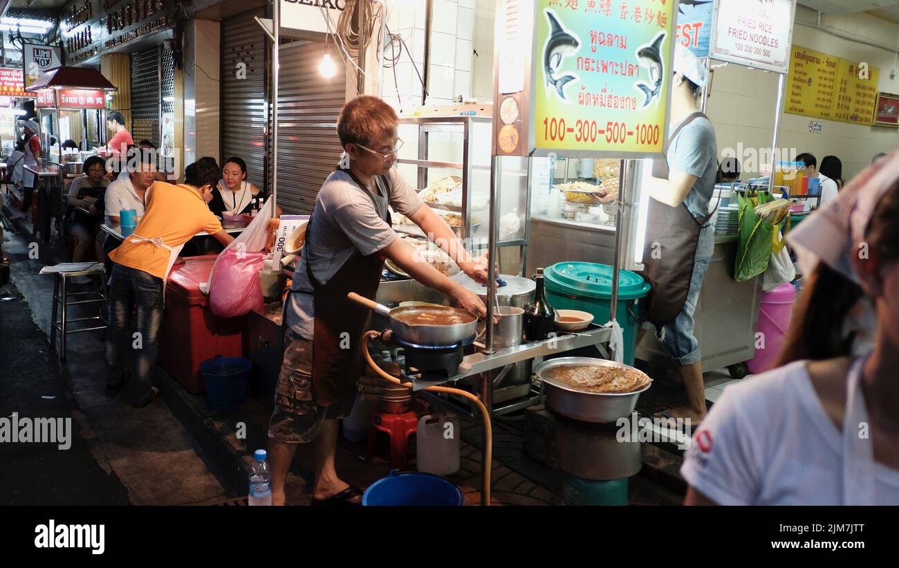 Local People enjoying Fast Street Food at Night Stock Photo - Alamy