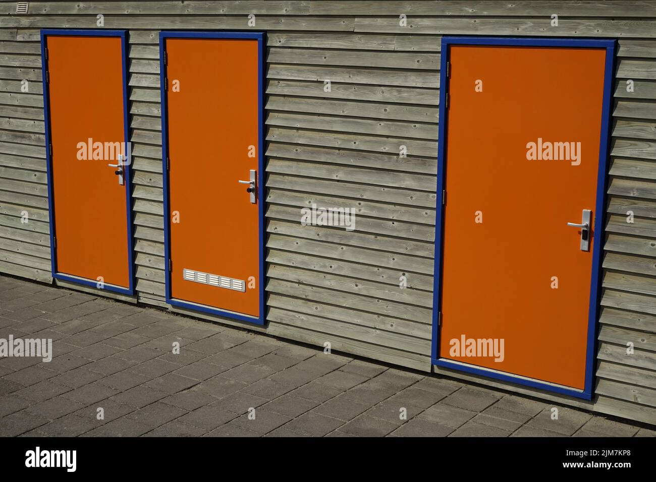 Orange doors with blue frames in wooden house wall (horizontal ...