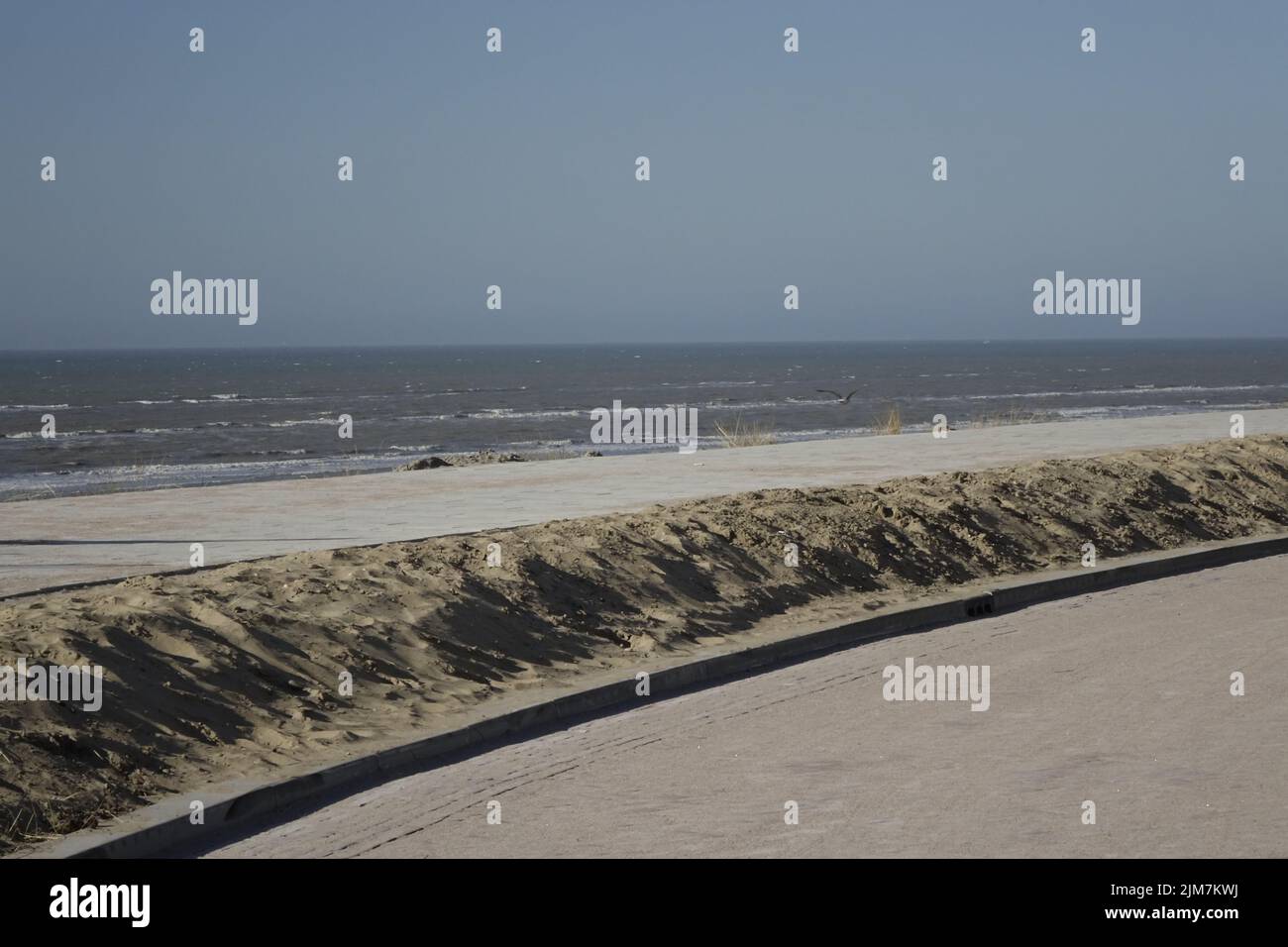 Panoramic ocean view with seagull, seen from brick street (horizontal ...