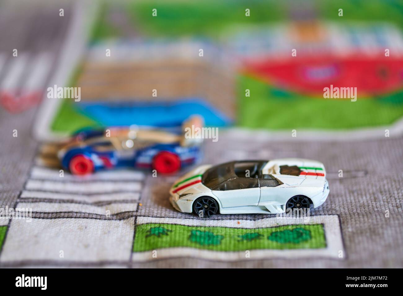 A mix of Hot Wheels toy model cars on a play road Stock Photo - Alamy