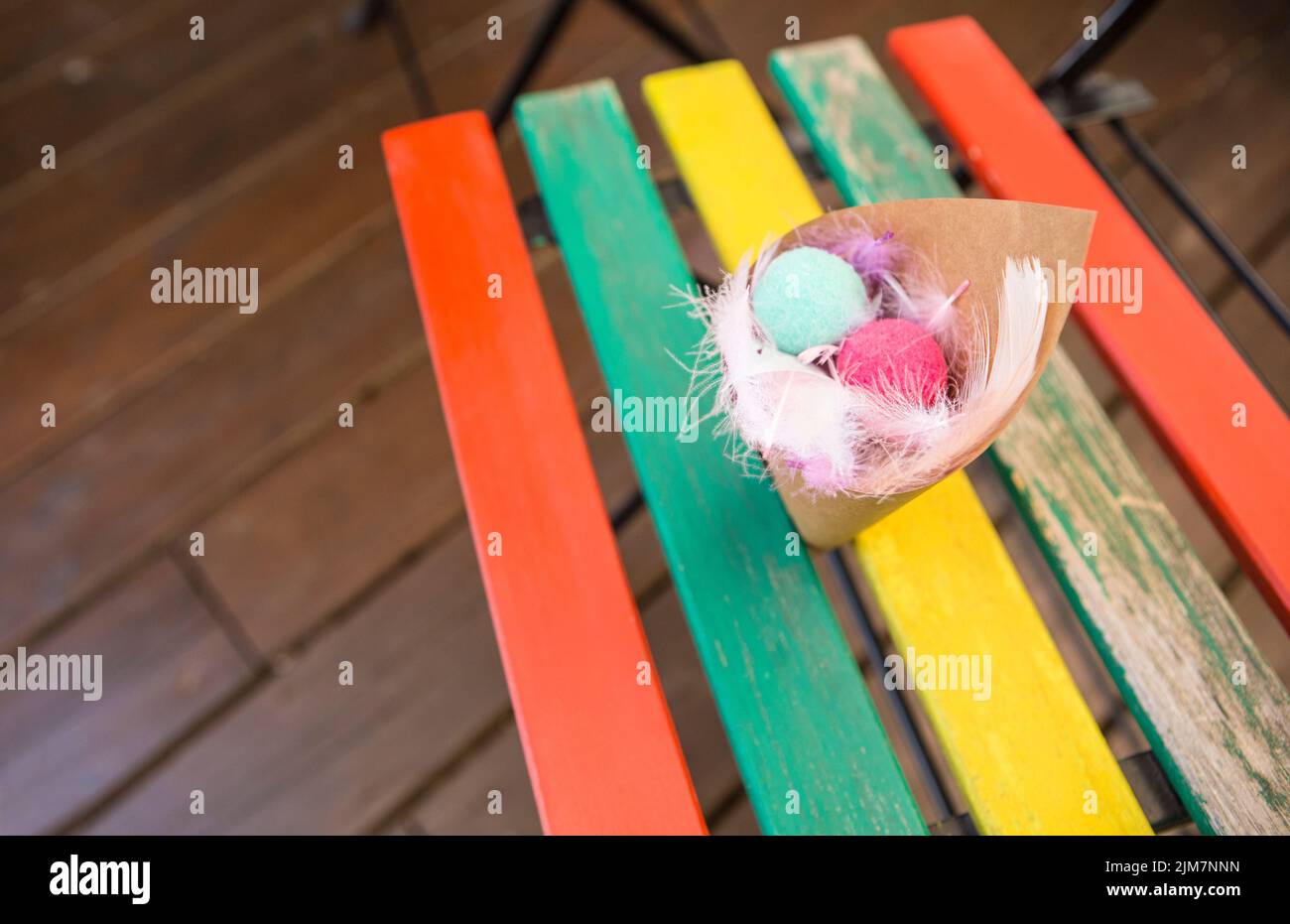 Cornets filled with colorful balls and feathers. Outdoor wedding ...