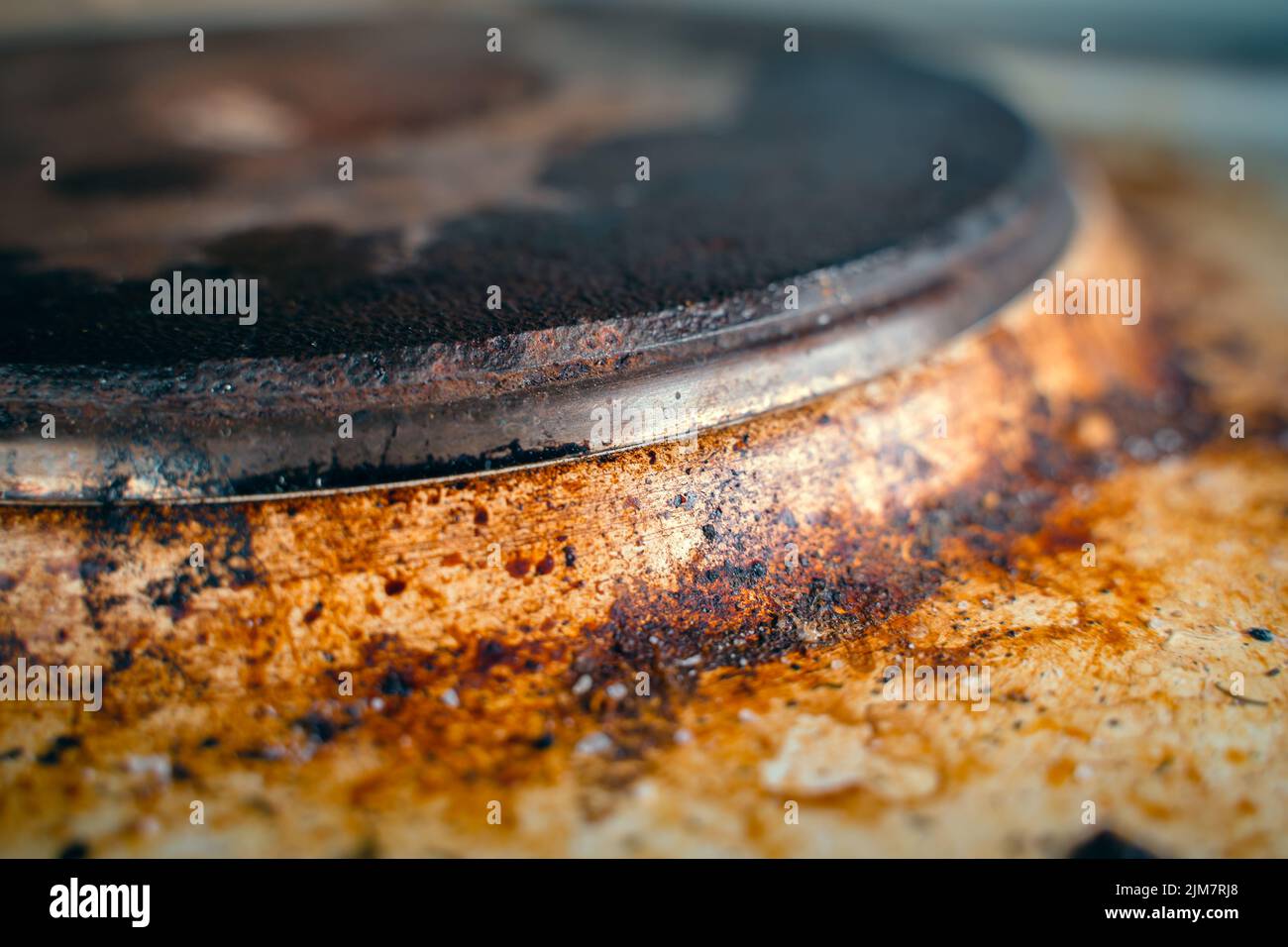 Old kitchen electric stove in heavy brown pollution and soot close up ...