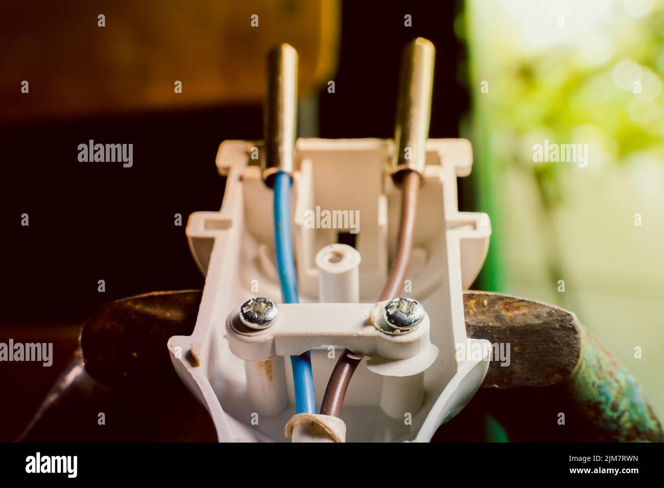Connecting the wires of an electrical appliance into an electrical plug ...