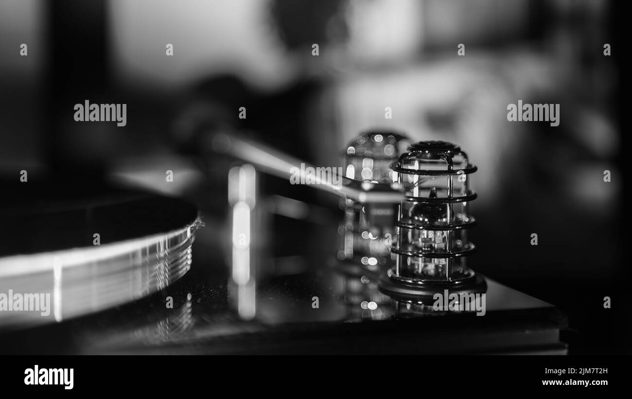 A grayscale closeup of the speed indicator of a turntable on a blurred ...