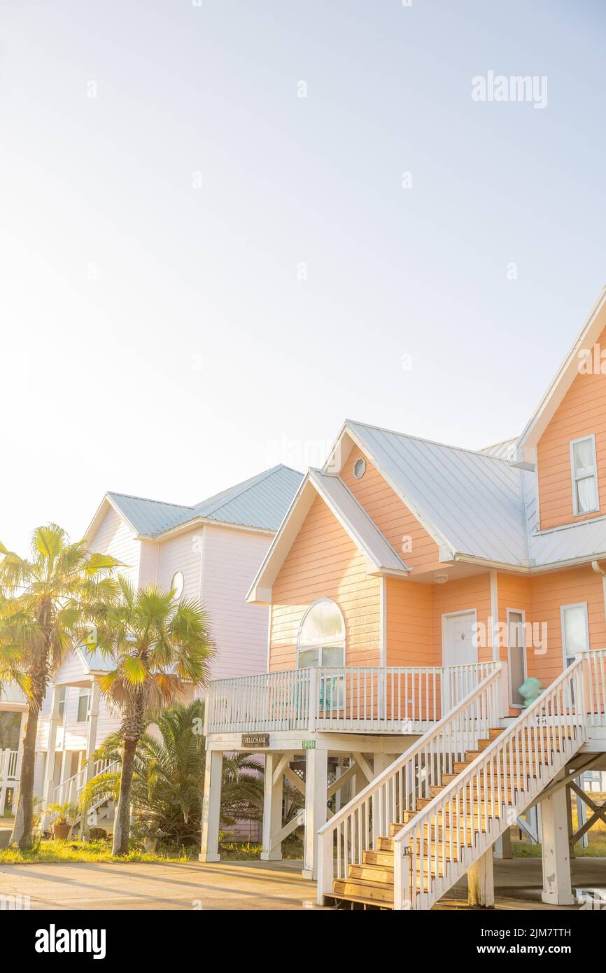 A vertical shot of beautiful colorful houses and palm trees on the ...