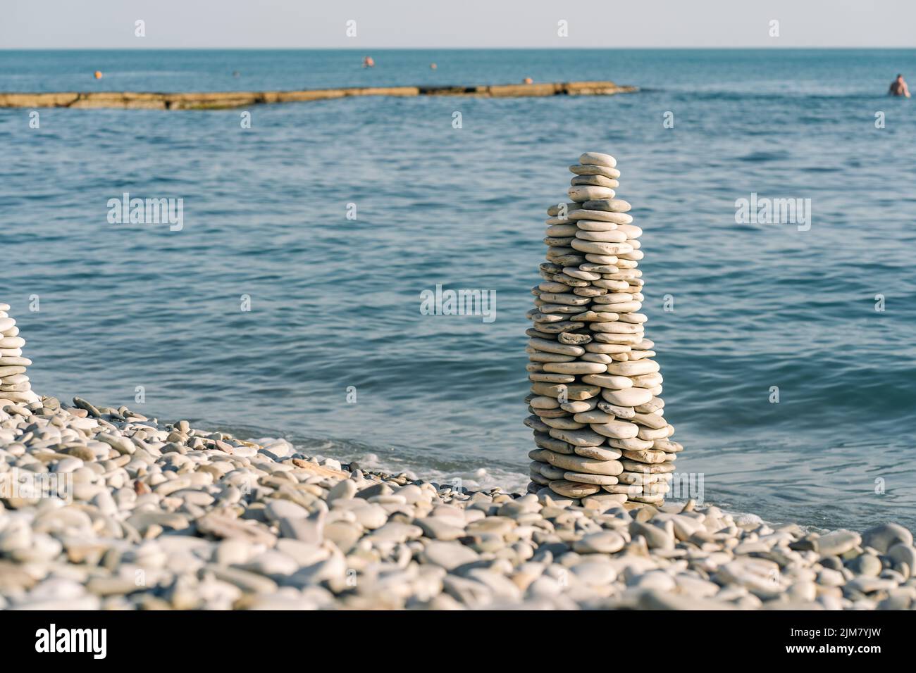 Balanced stones on a pebble beach. Sea stones arranged in a balance ...