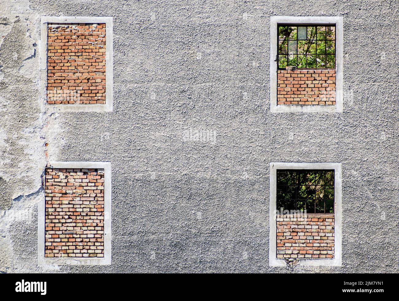 The wall of the old house with bricked-up windows. Texture, background ...