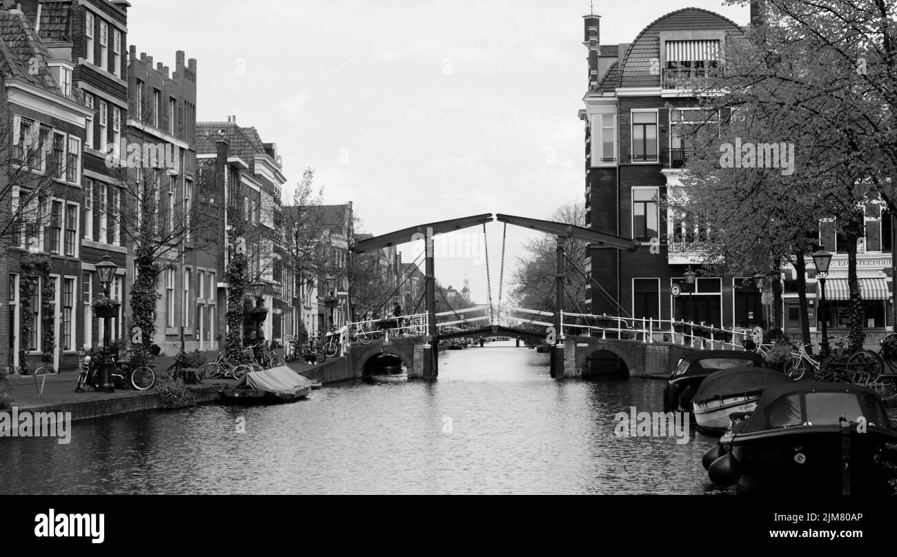A beautiful view of a small bridge over the river between buildings ...