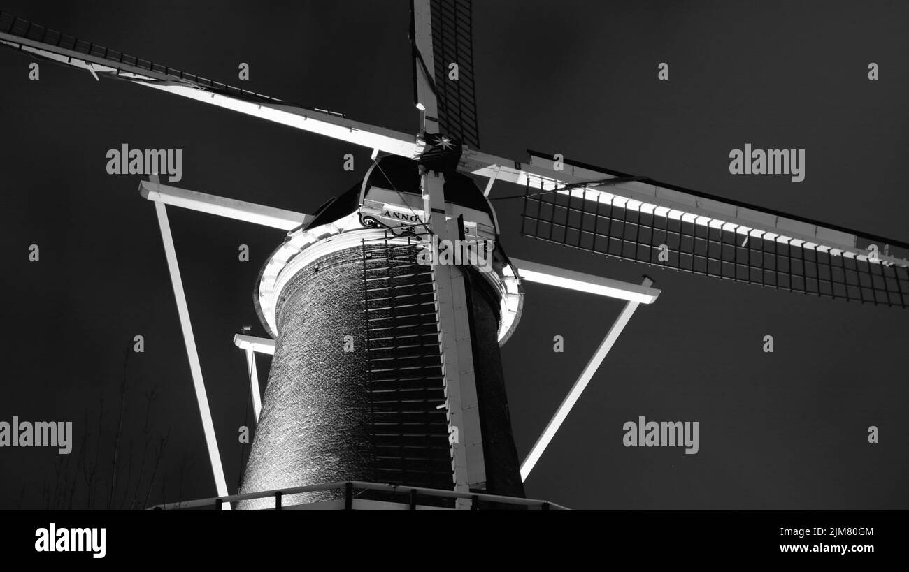 A grayscale of a windmill on a black background Stock Photo - Alamy