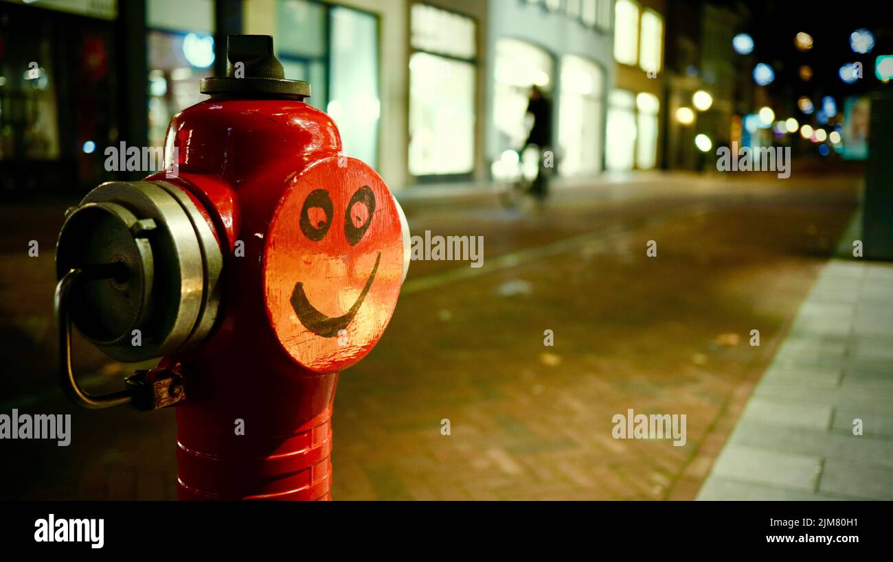A closeup of a fire hydrant with a happy smile Stock Photo - Alamy
