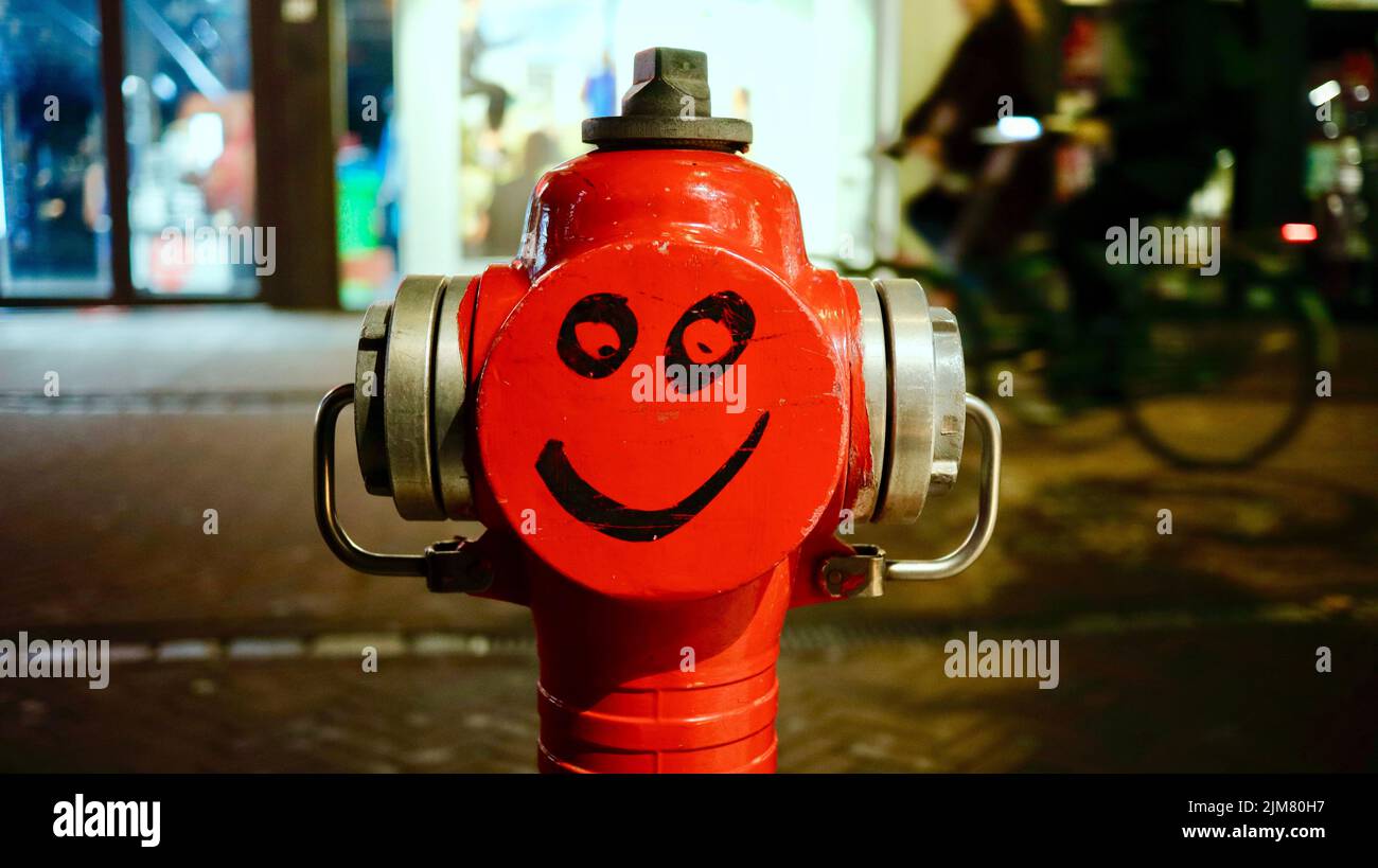A closeup of a fire hydrant with a happy smile Stock Photo - Alamy