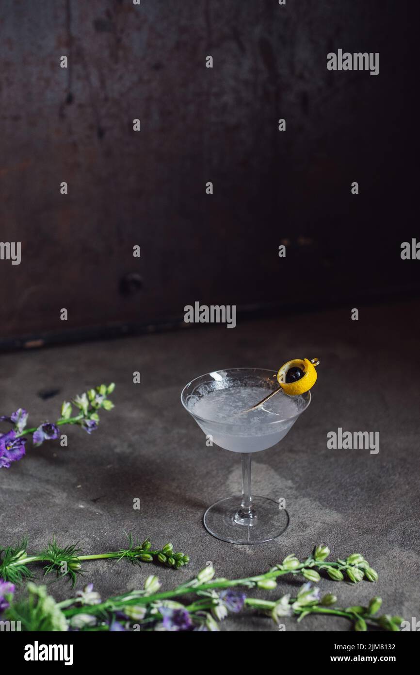 purple gin Aviation cocktail with lemon and cherry garnish on concrete ...