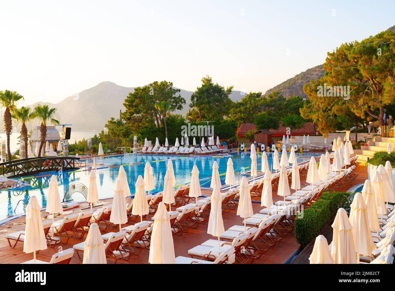Pool with lounge chairs in resort hotel with mountain view Stock Photo ...