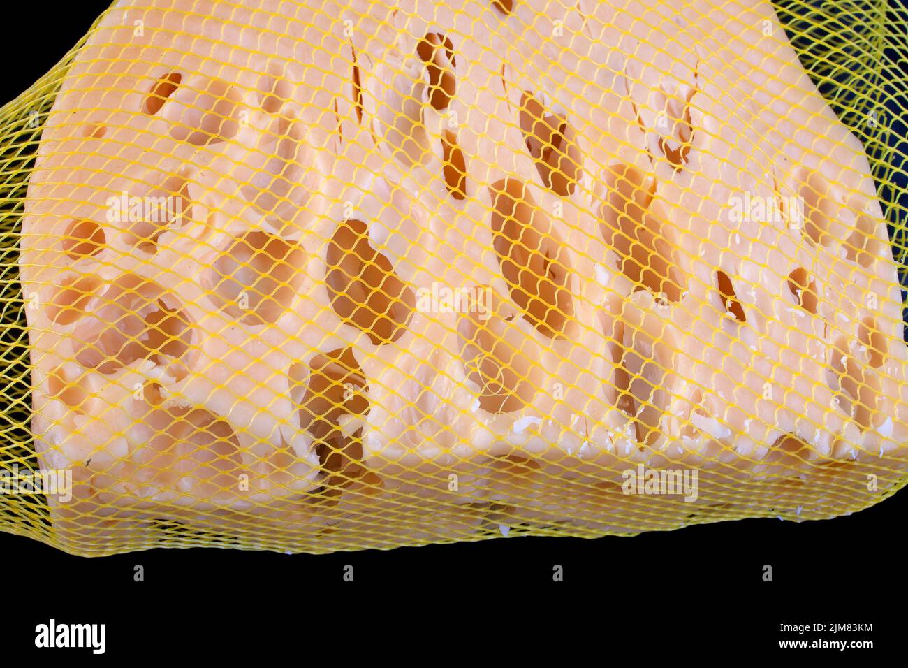 Cheese slice in net Stock Photo - Alamy